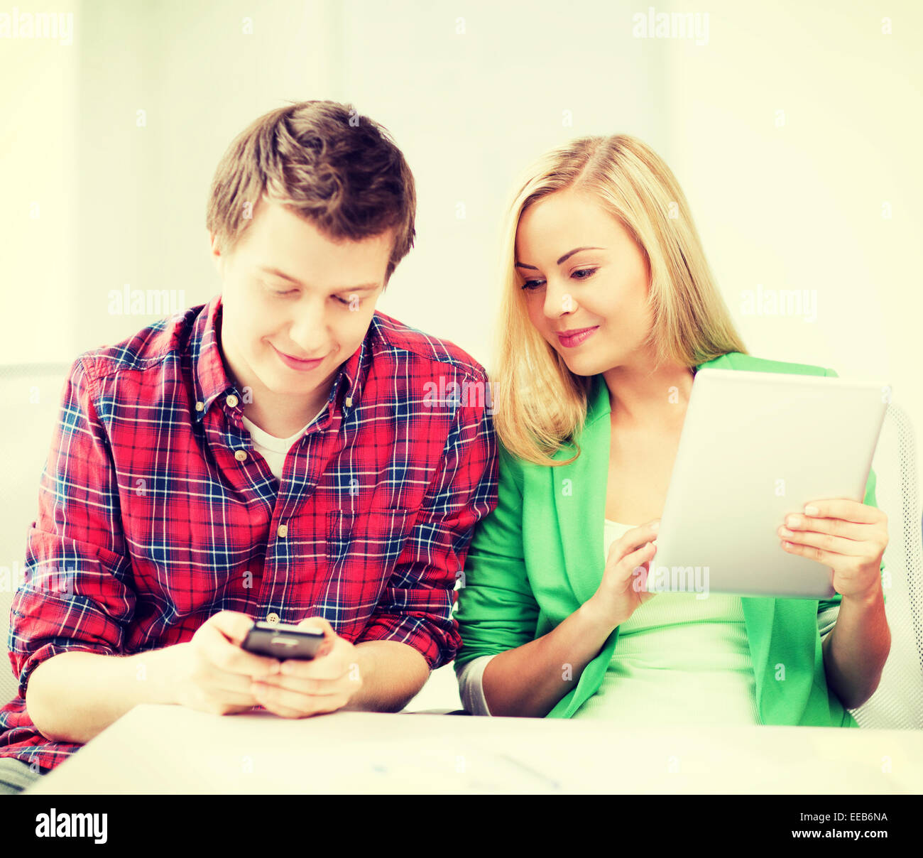 students using smartphone and tablet pc at school Stock Photo - Alamy