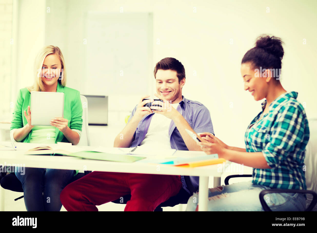 students looking into devices at school Stock Photo - Alamy