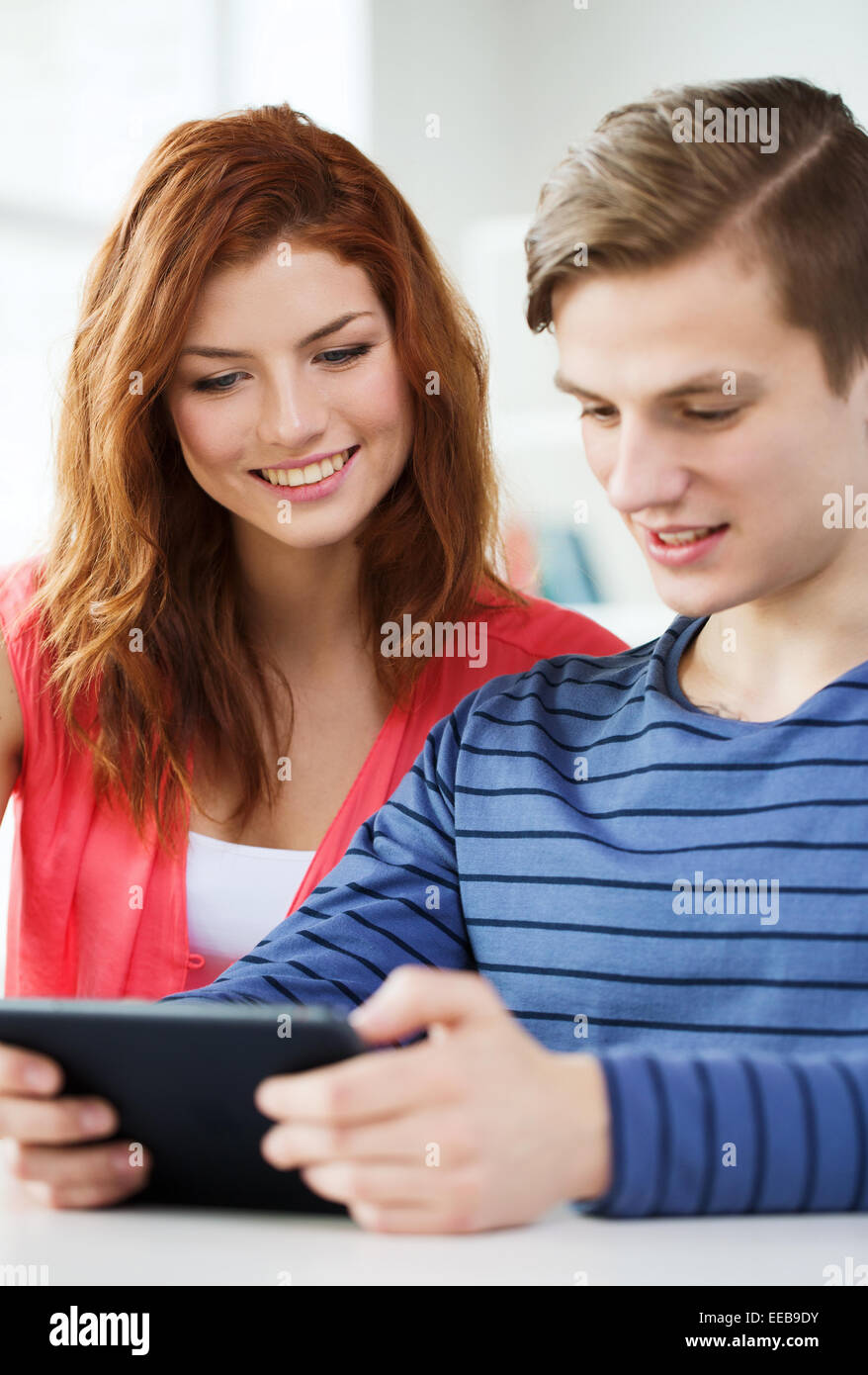 smiling students with tablet pc at school Stock Photo - Alamy