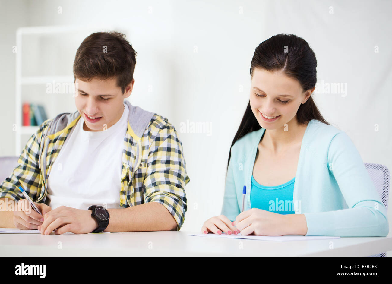 smiling students with textbooks at school Stock Photo - Alamy