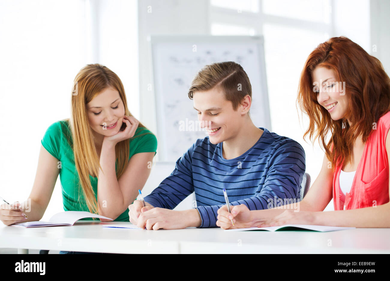 smiling students with textbooks at school Stock Photo - Alamy