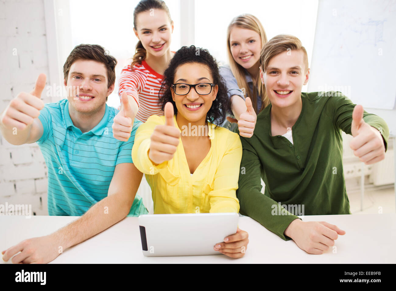 smiling students with tablet pc computer at school Stock Photo - Alamy