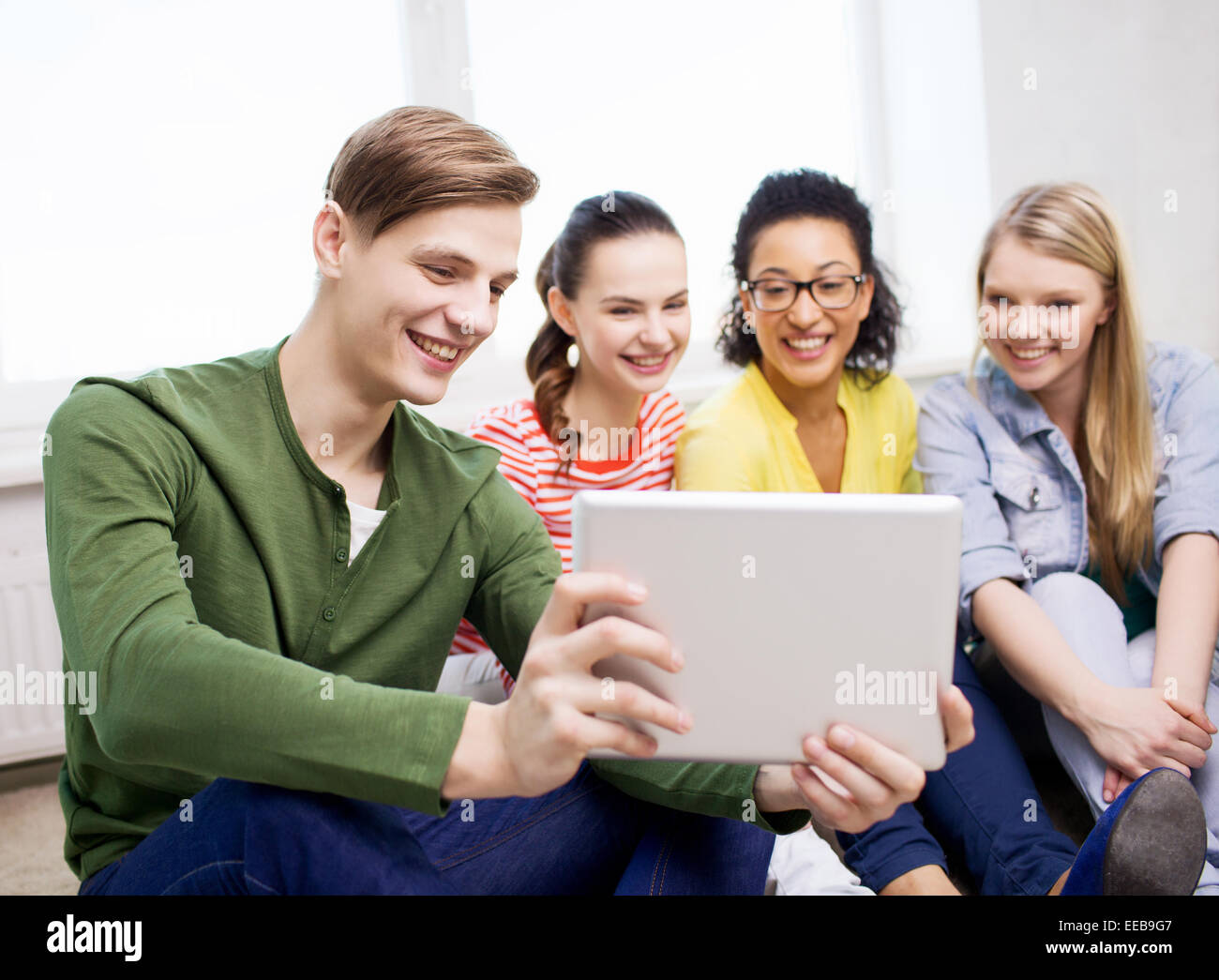 smiling students making picture with tablet pc Stock Photo - Alamy
