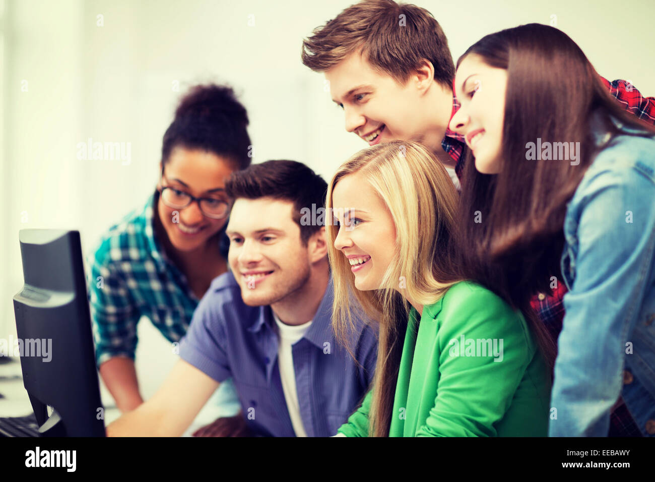 students looking at computer monitor at school Stock Photo - Alamy
