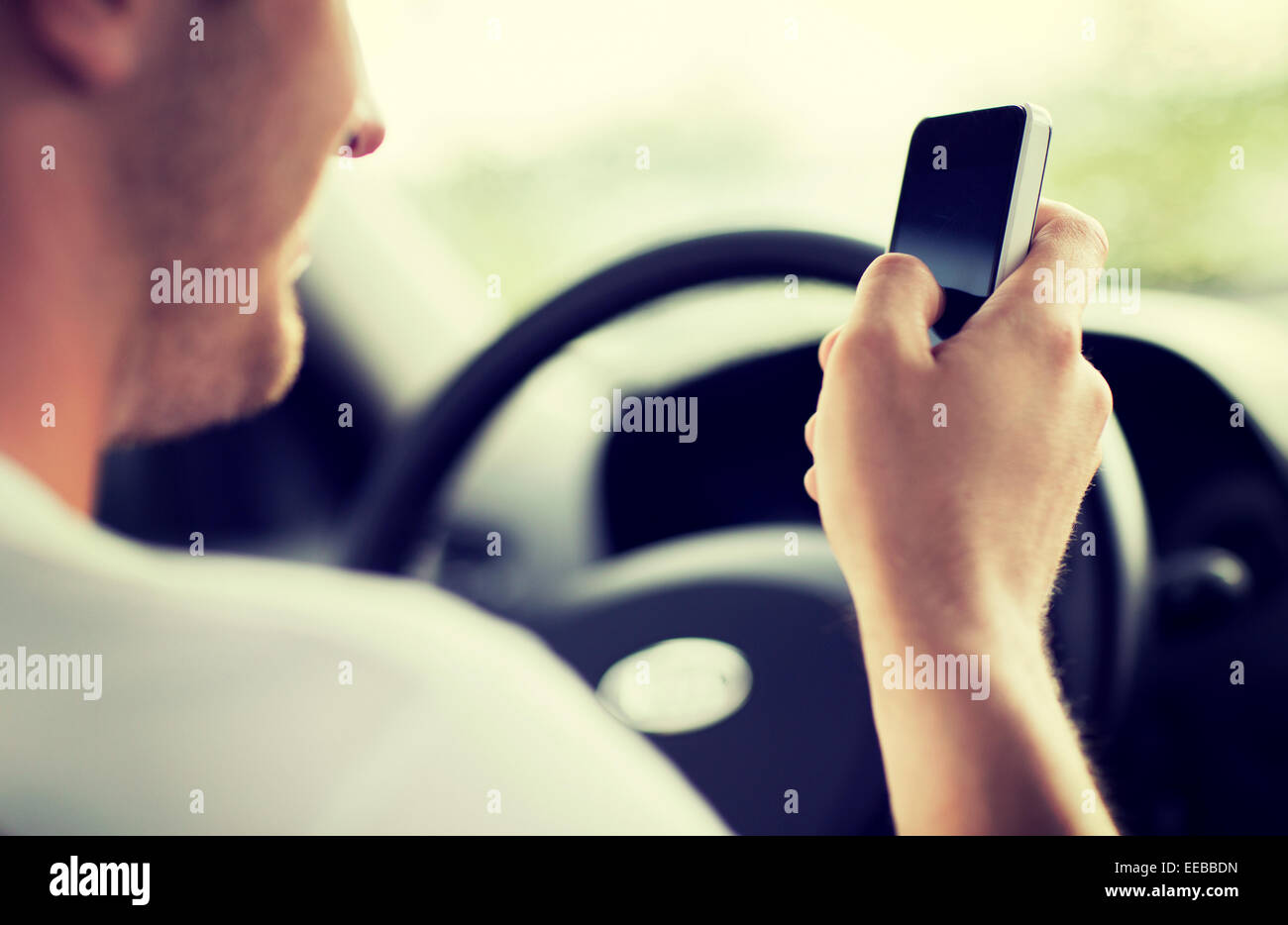 man using phone while driving the car Stock Photo - Alamy