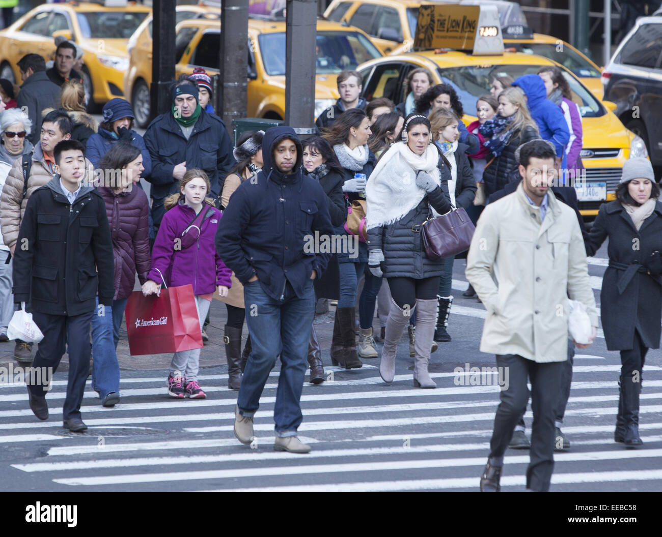 Crowds of people walk along 5th Ave. at 42nd St. in midtown Manhattan ...