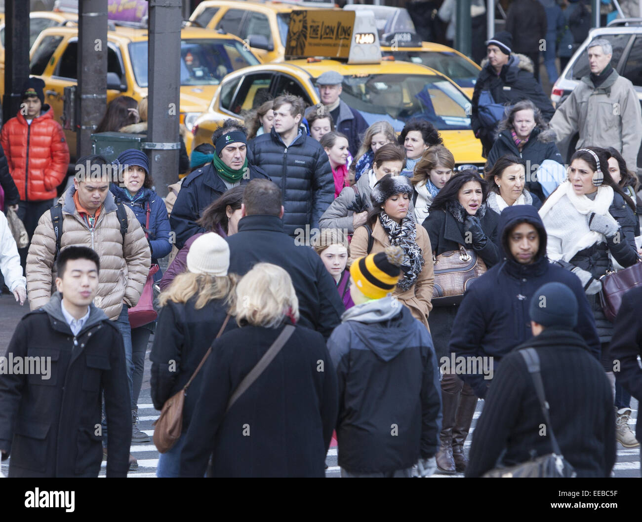Crowds of people walk along 5th Ave. at 42nd St. in midtown Manhattan ...