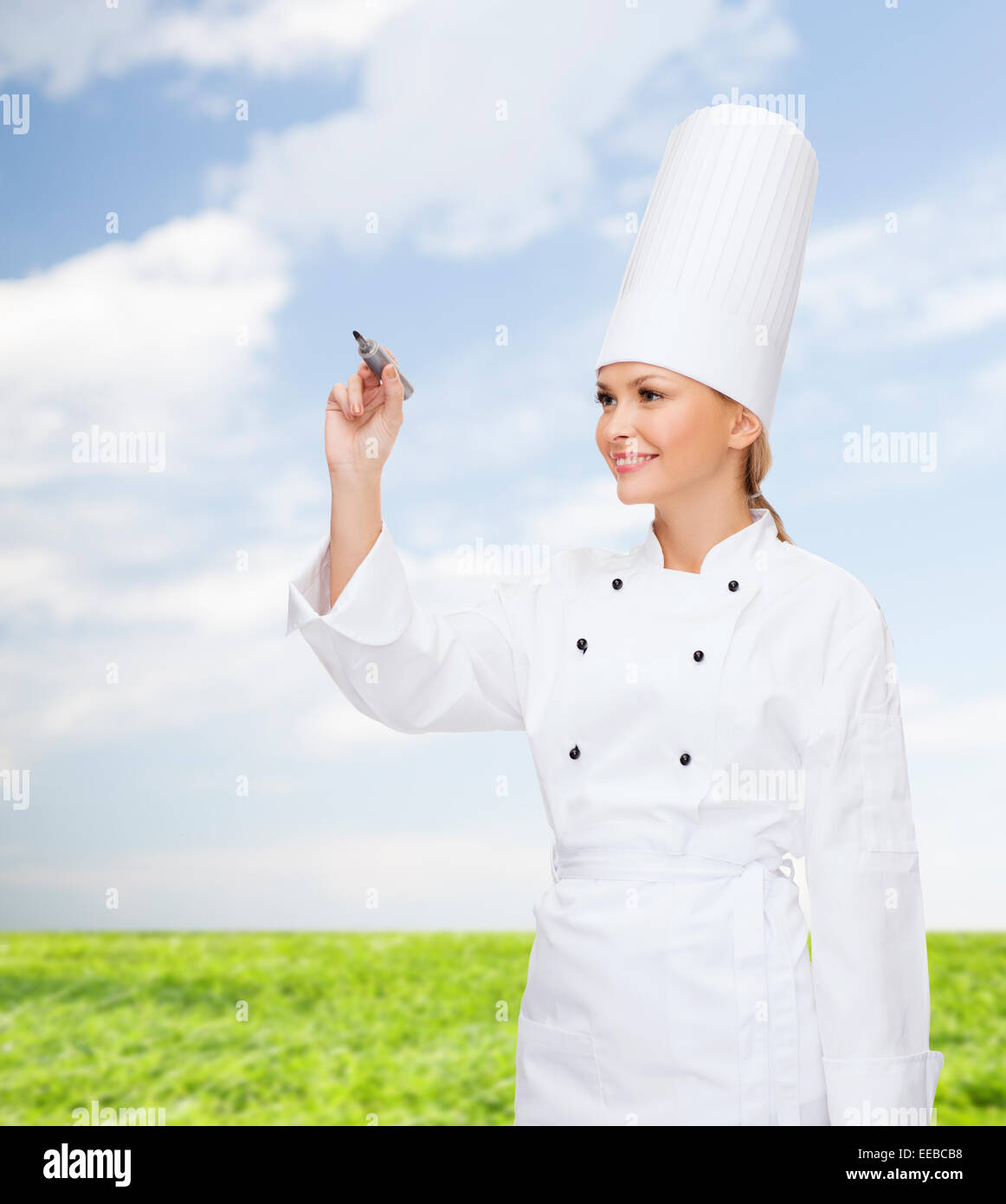 smiling female chef writing something on air Stock Photo - Alamy