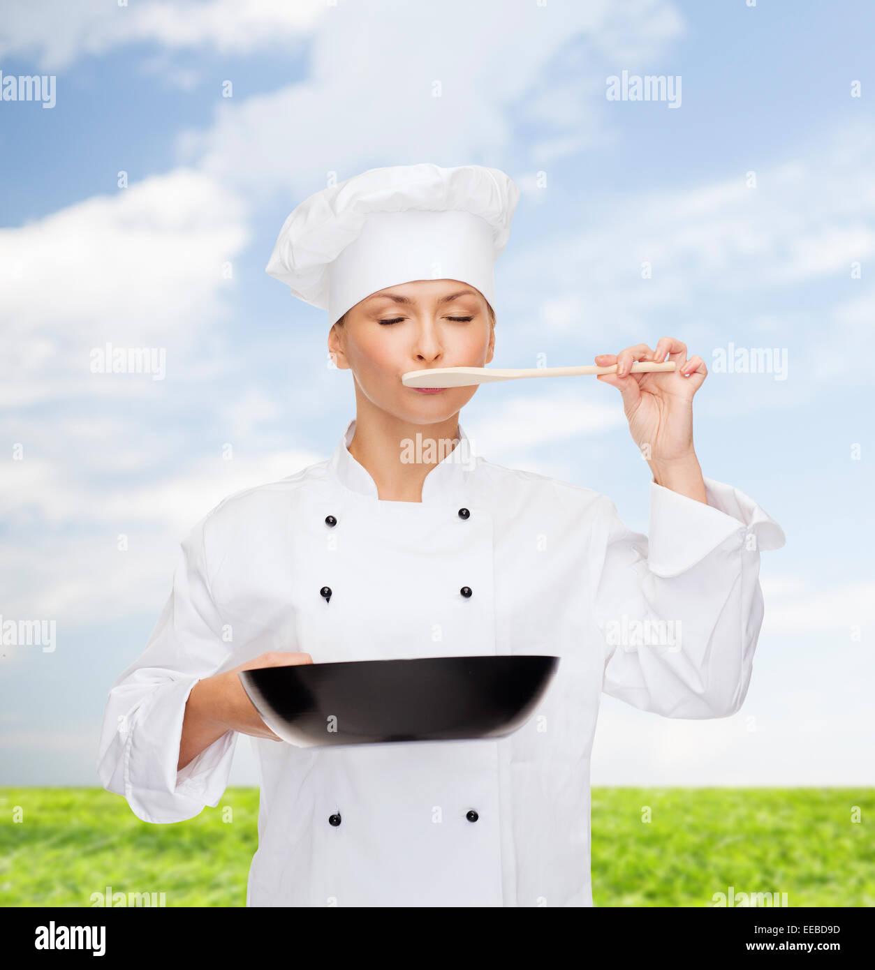 smiling female chef with pan and spoon Stock Photo - Alamy
