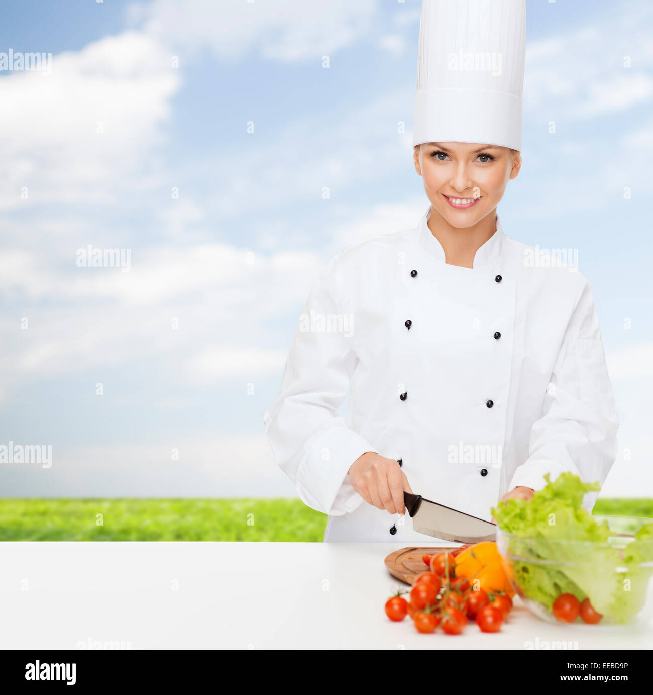 smiling female chef chopping vegetables Stock Photo - Alamy