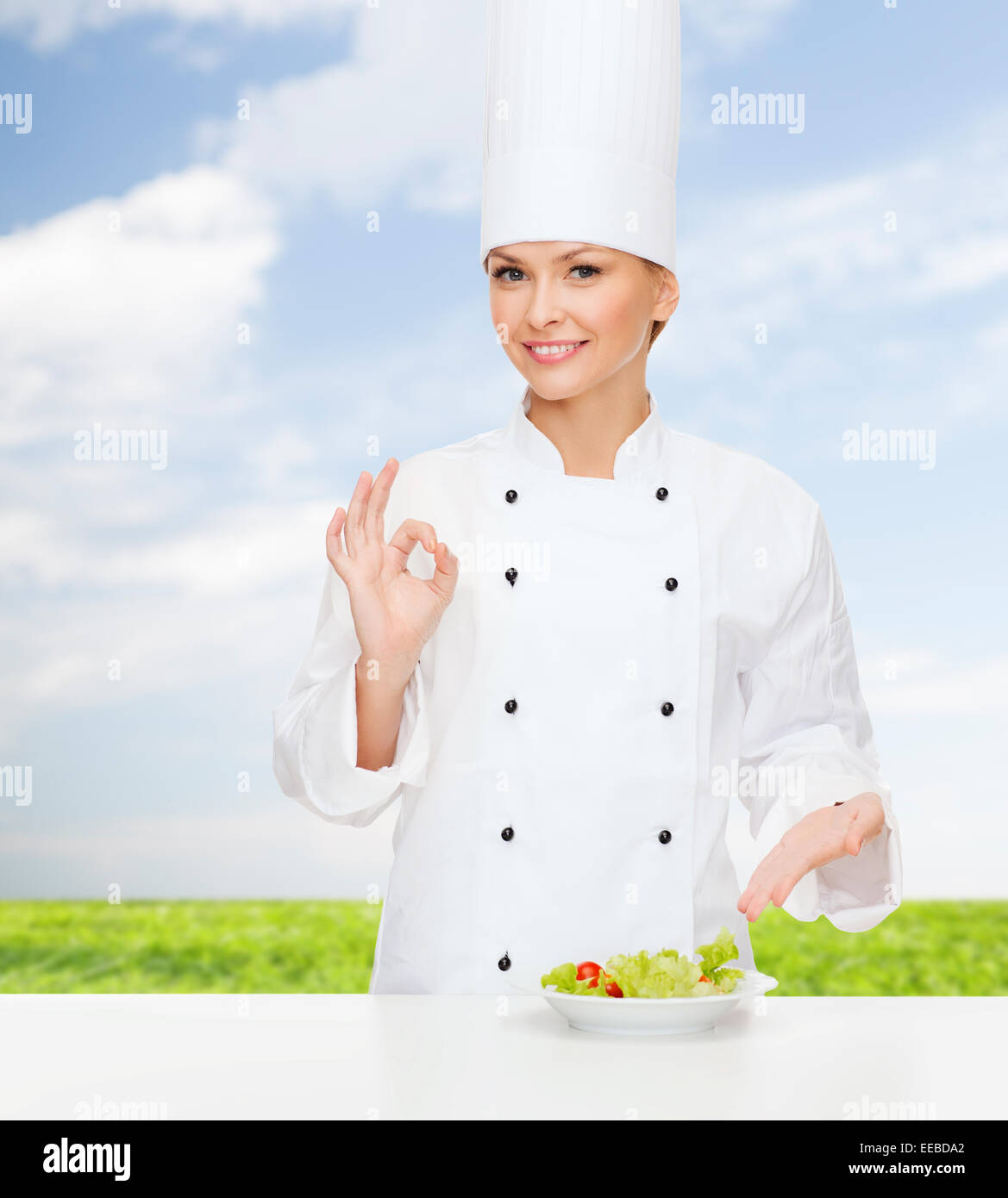 smiling female chef with salad on plate Stock Photo - Alamy