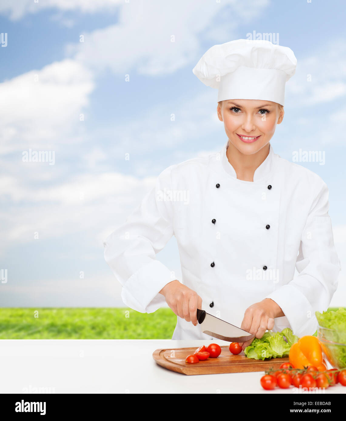 smiling female chef chopping vegetables Stock Photo - Alamy