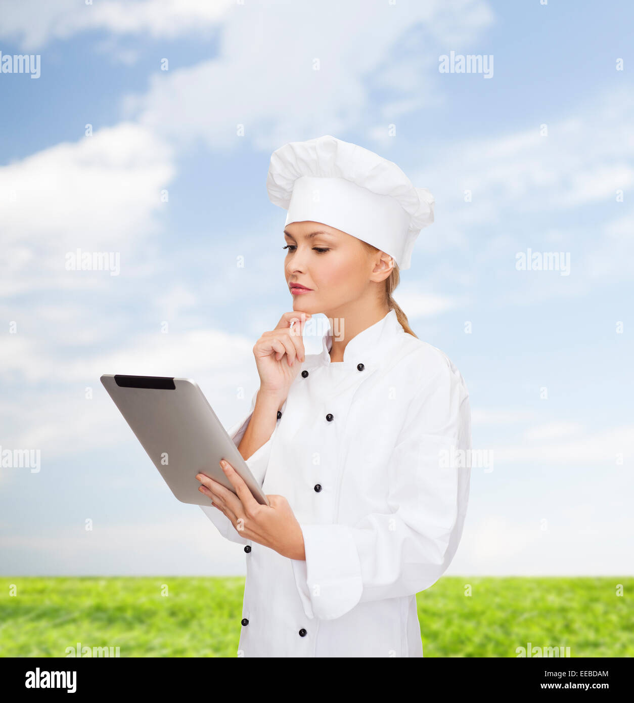 smiling female chef with tablet pc computer Stock Photo - Alamy