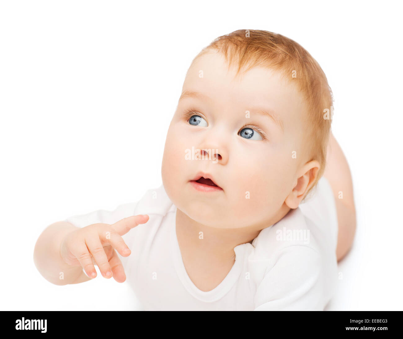 curious baby lying on floor and looking side Stock Photo - Alamy
