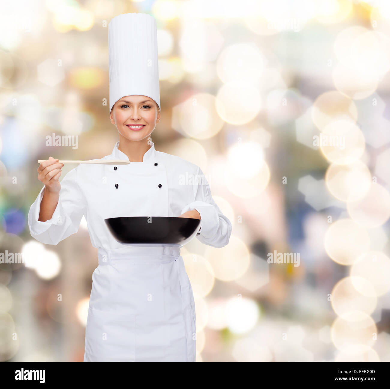 smiling female chef with pan and spoon Stock Photo - Alamy