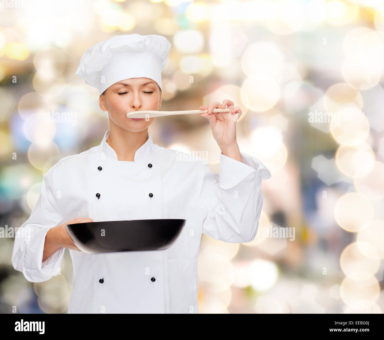 smiling female chef with pan and spoon Stock Photo - Alamy