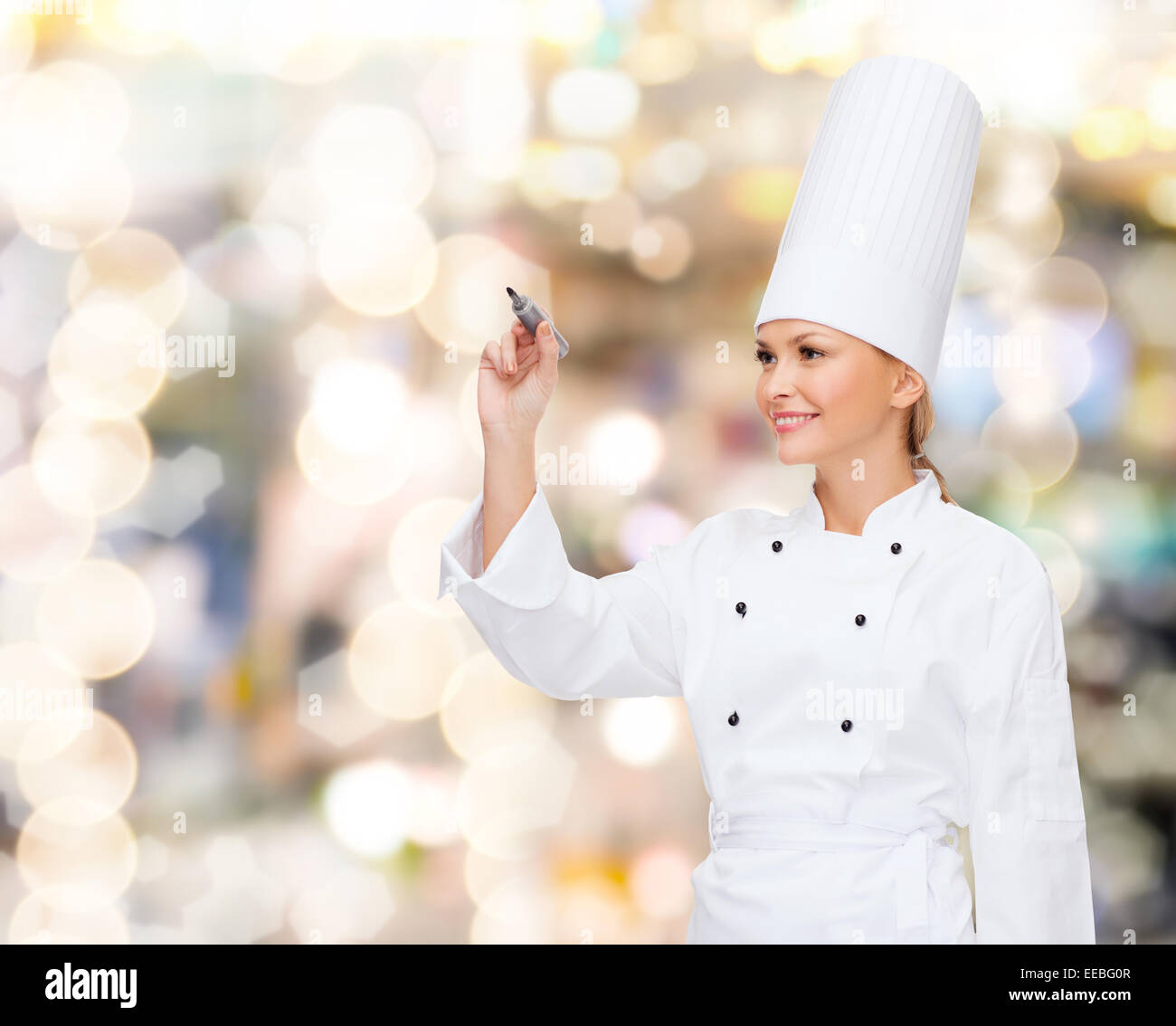 smiling female chef writing something on air Stock Photo - Alamy