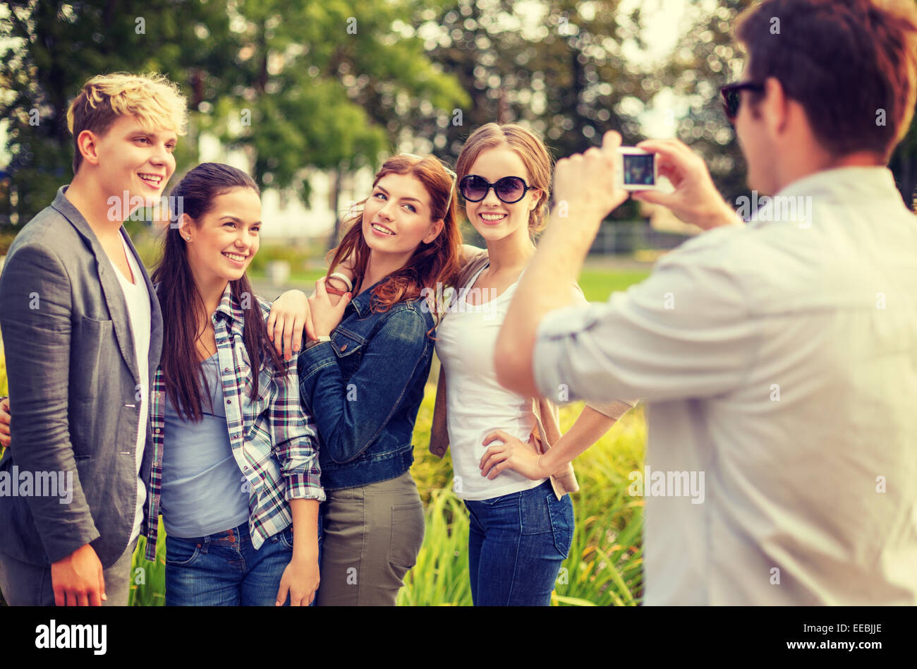 teenagers taking photo with digital camera outside Stock Photo - Alamy