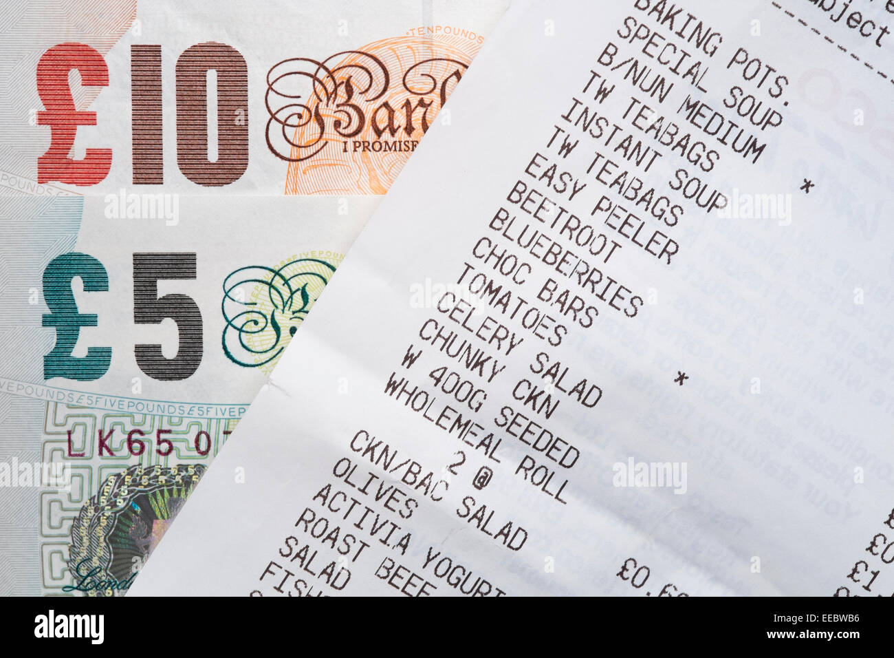 Supermarket grocery till purchase receipt with GB pound currency notes ...