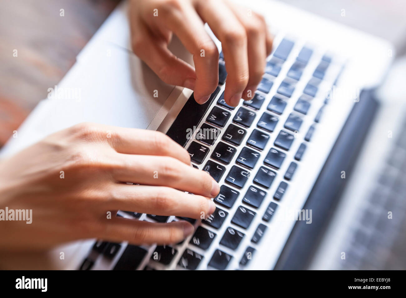 Female hands typing text on the keyboard, top view Stock Photo - Alamy