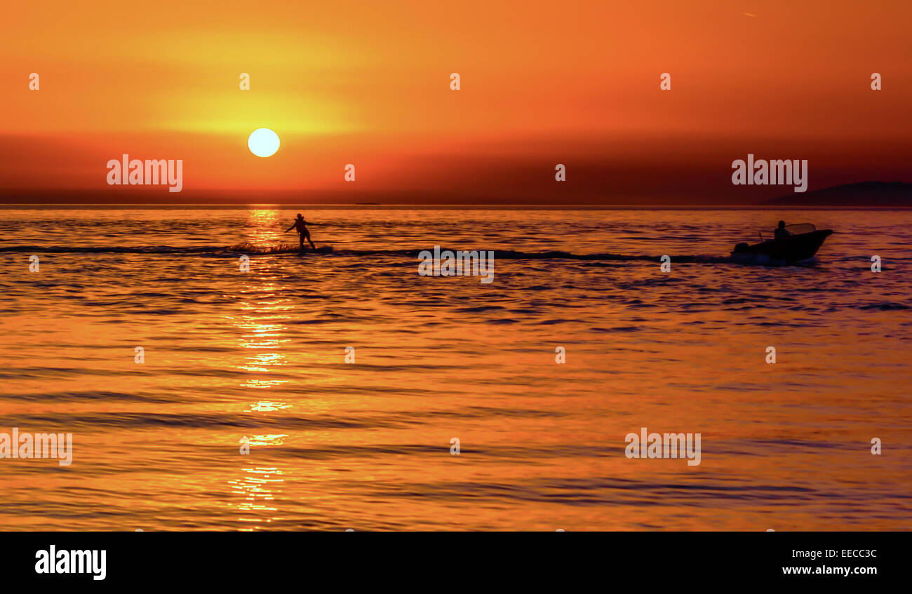 Boat in the sunset Stock Photo - Alamy