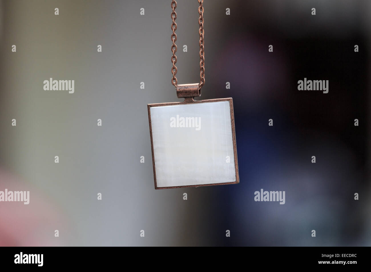 A white square necklace on a string Stock Photo - Alamy