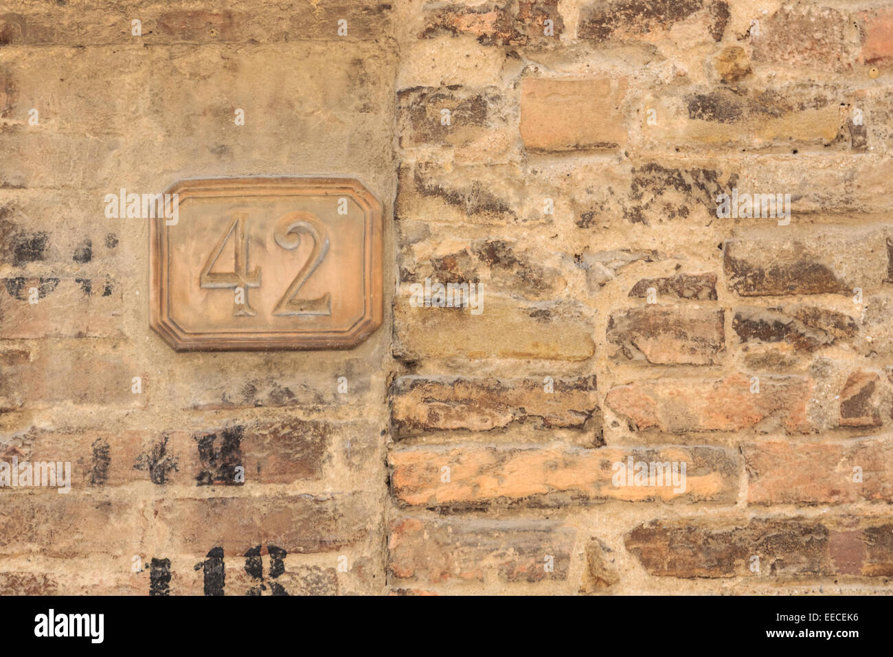 House number 42 on a yellow brick wall Stock Photo - Alamy