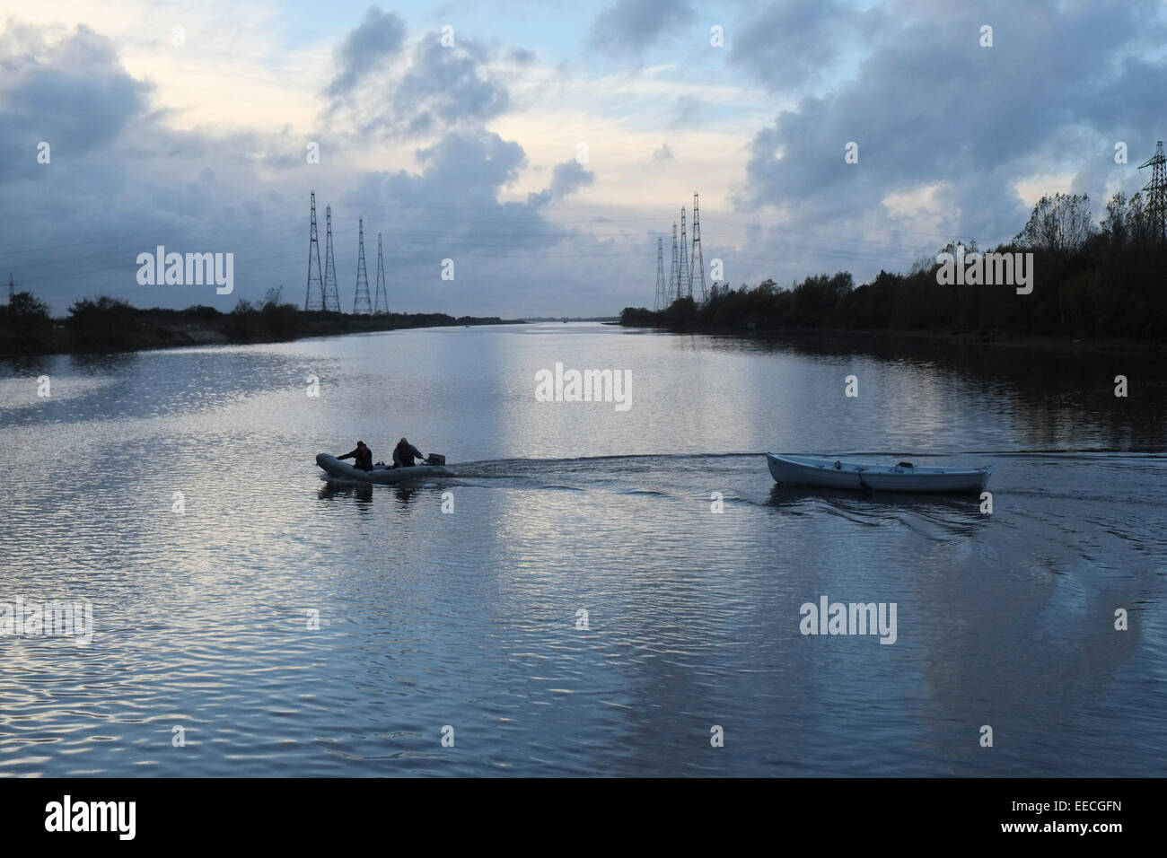 Preston, Lancashire: Two men in a dinghy towing a rowing boat on the ...
