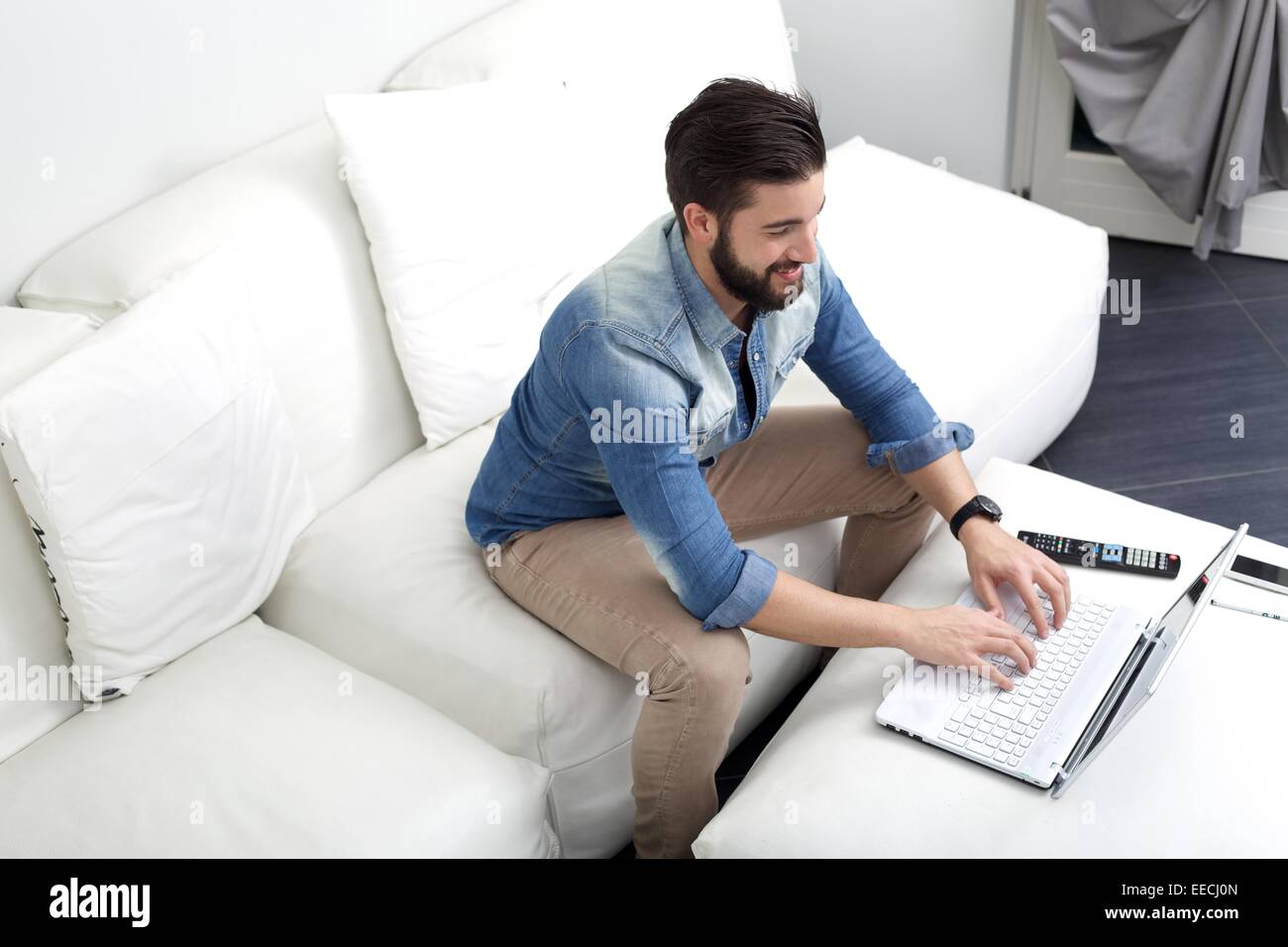 Young man relaxing home watching hi-res stock photography and images ...