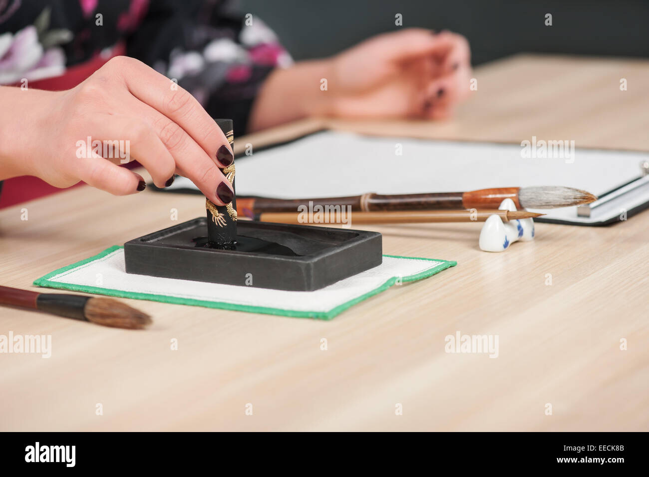 Traditional calligraphy on wooden table Stock Photo - Alamy