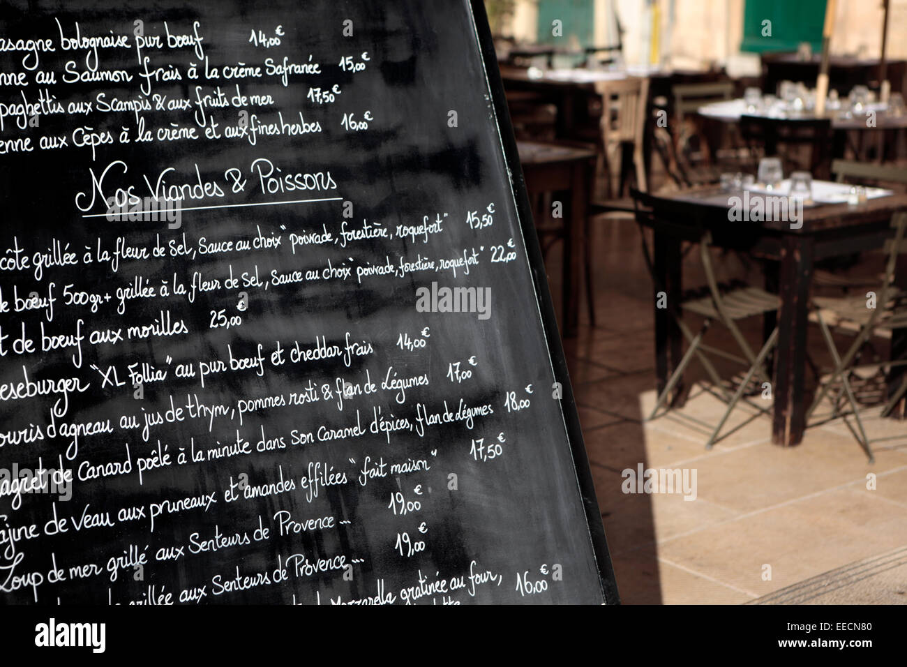 Paris, France restaurant menu board with tables and chairs in the ...