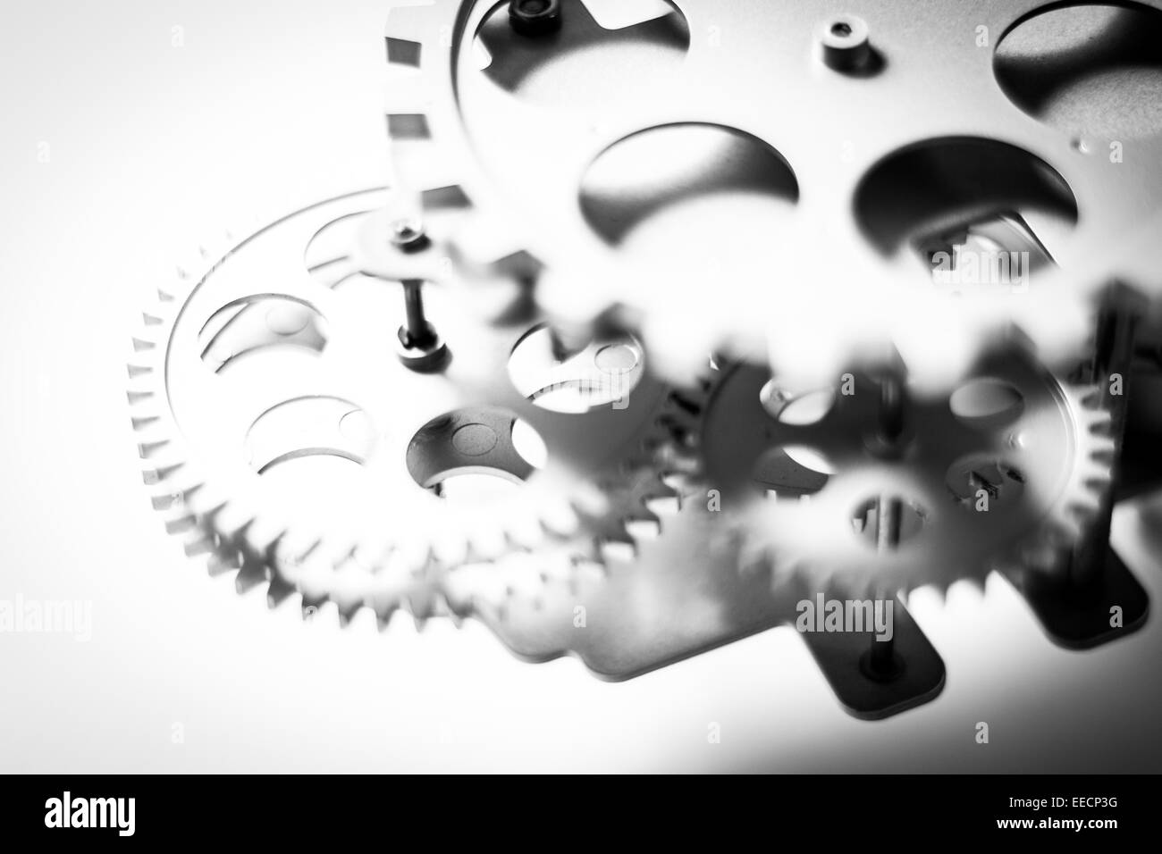 A group of silver gears functioning together in a precision machinery ...