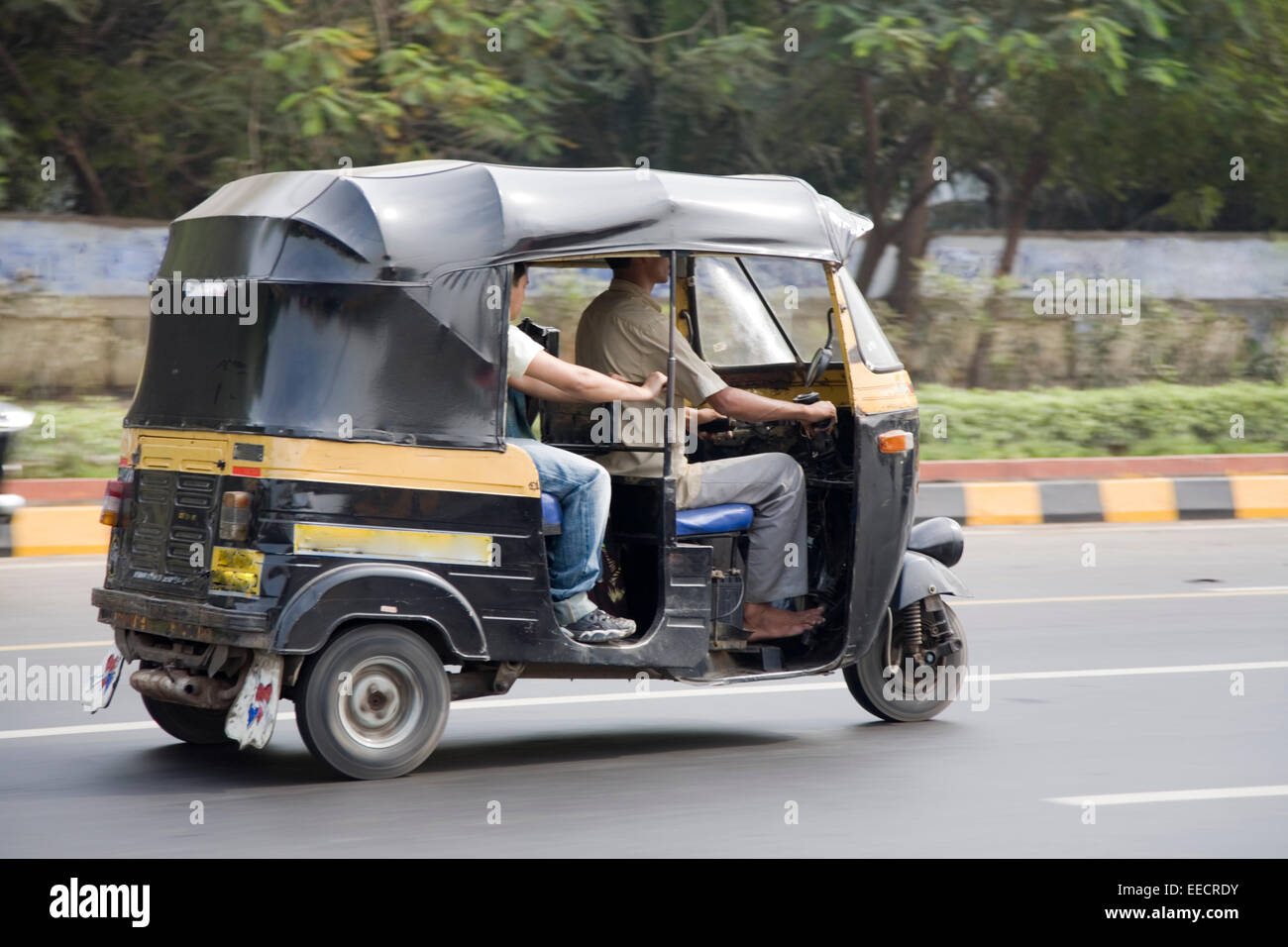 Auto rickshaw transport with driver and passenger on the road in Mumbai ...