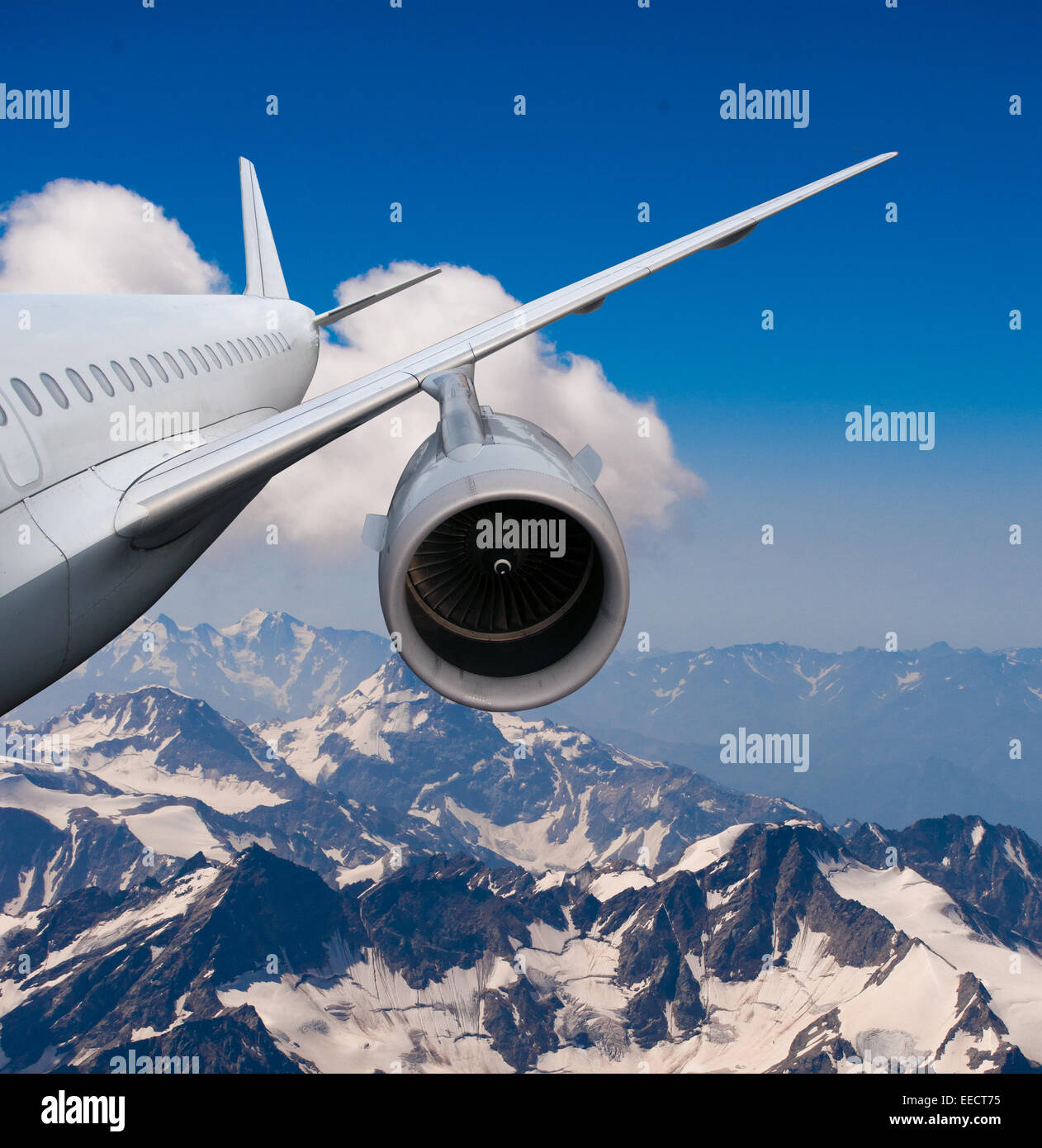 plane flying over the snow-capped mountains. airplane flying down ...