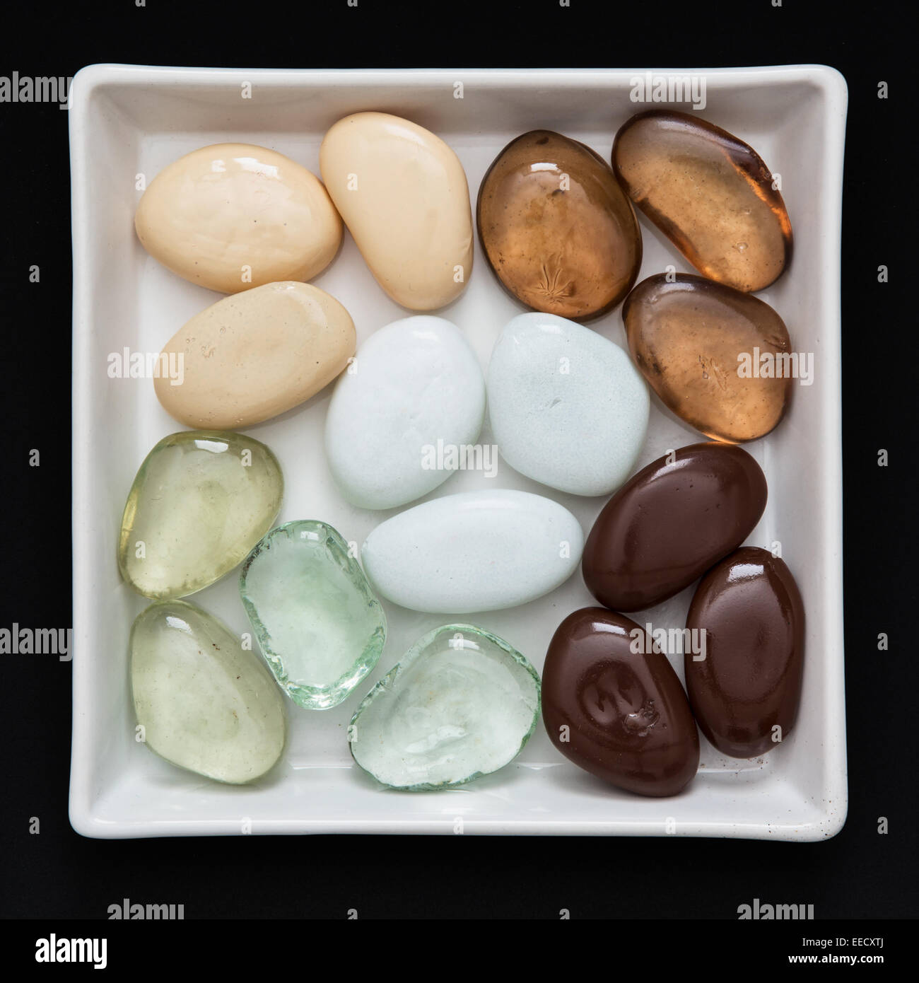 Various shiny decorative pebbles in the white bowl Stock Photo - Alamy