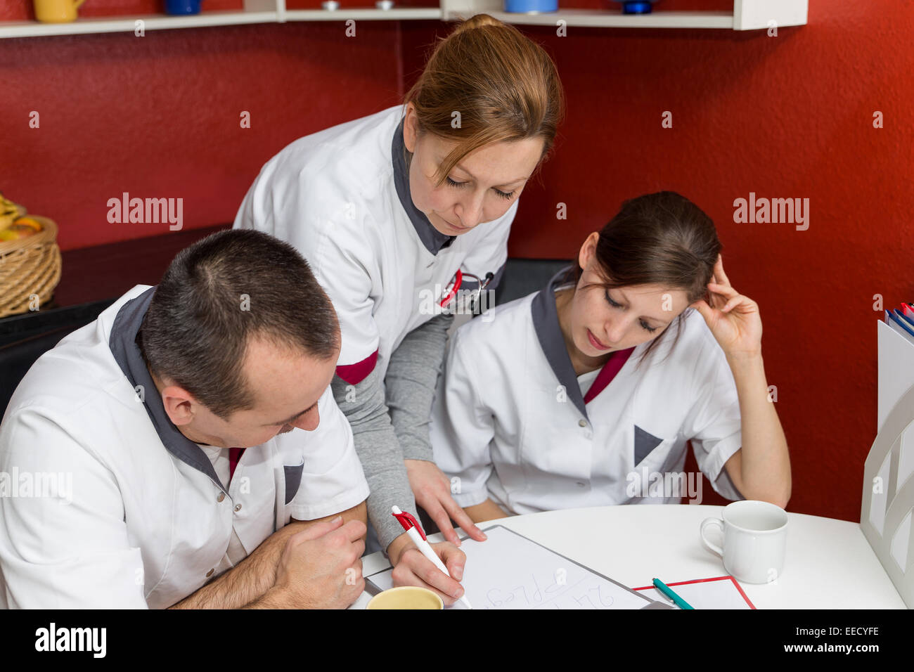 nurse instructs other employees in the break room Stock Photo - Alamy