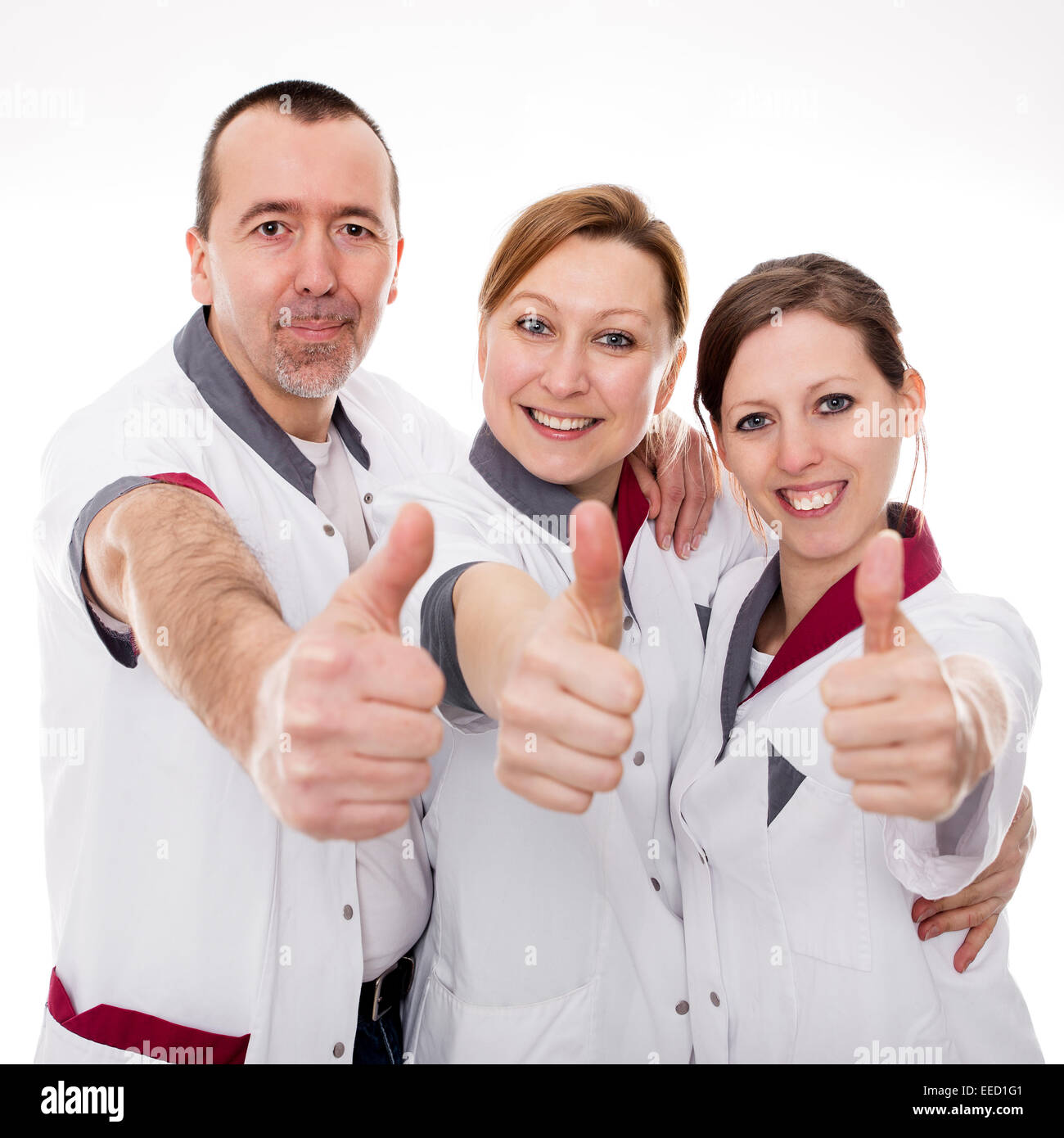 three nurses demonstrate teamwork and success in front of white Stock ...