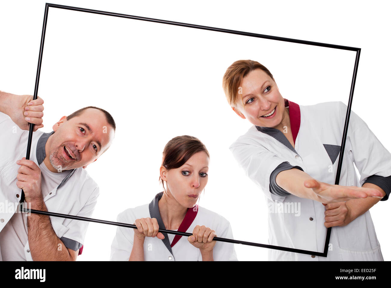 three nurses are looking through a frame isolated on white Stock Photo ...