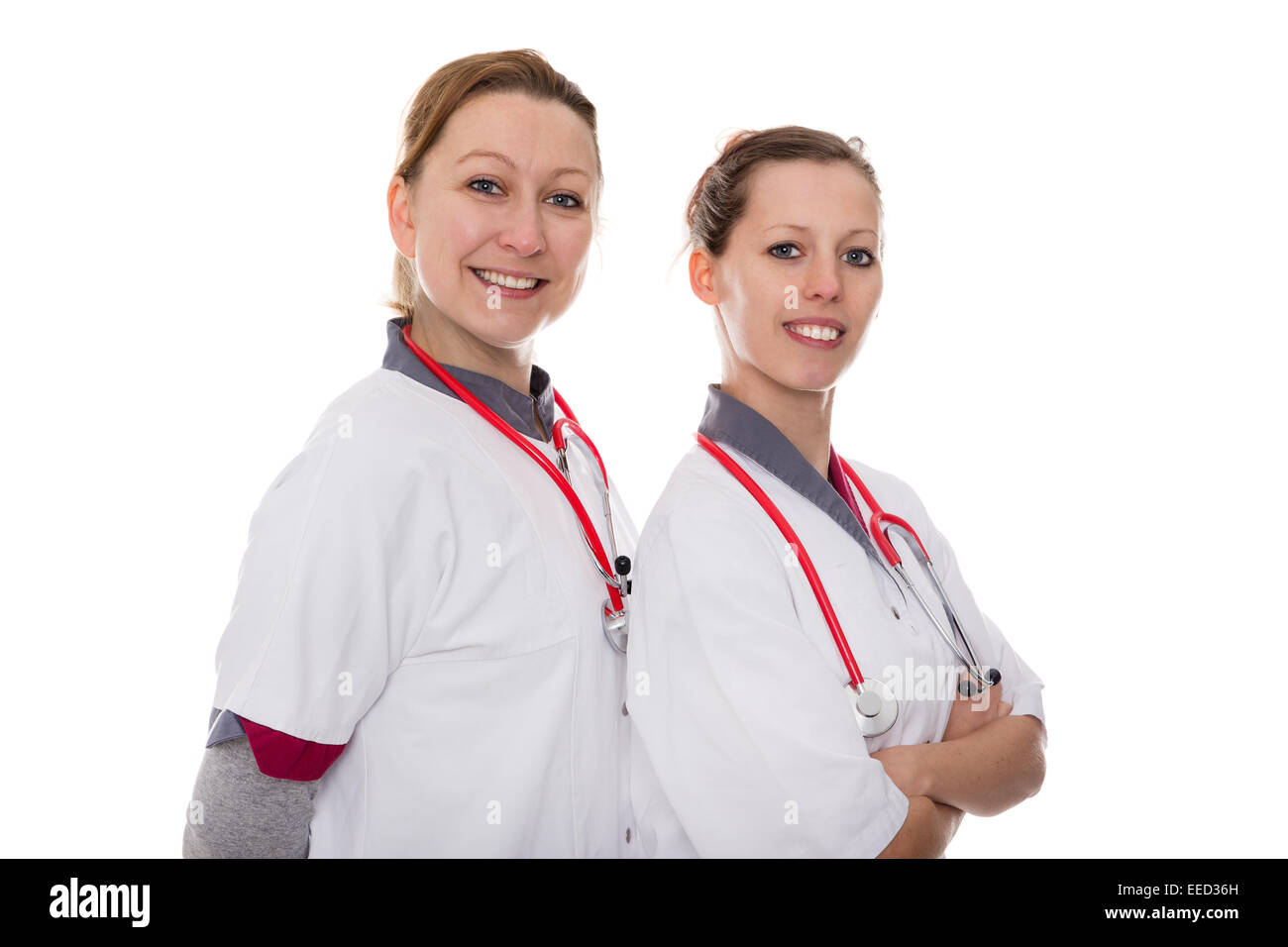 two female doctors smiling to the viewer, isolated on white Stock Photo ...