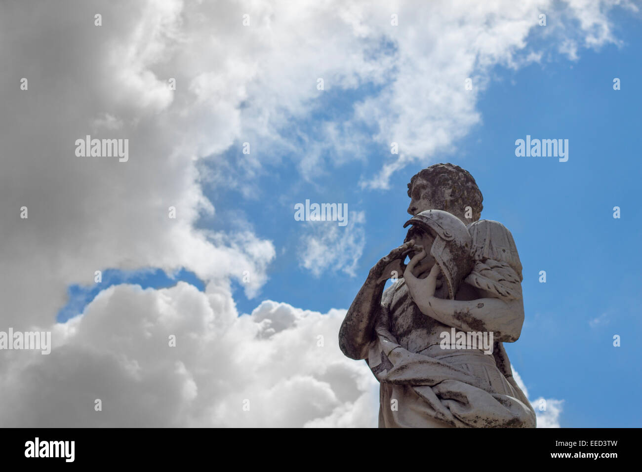 contrast between clouds and statue Stock Photo - Alamy