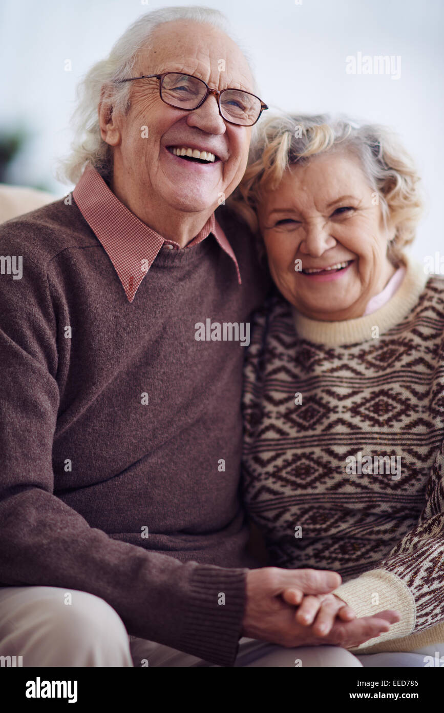 Ecstatic seniors in sweaters laughing Stock Photo - Alamy