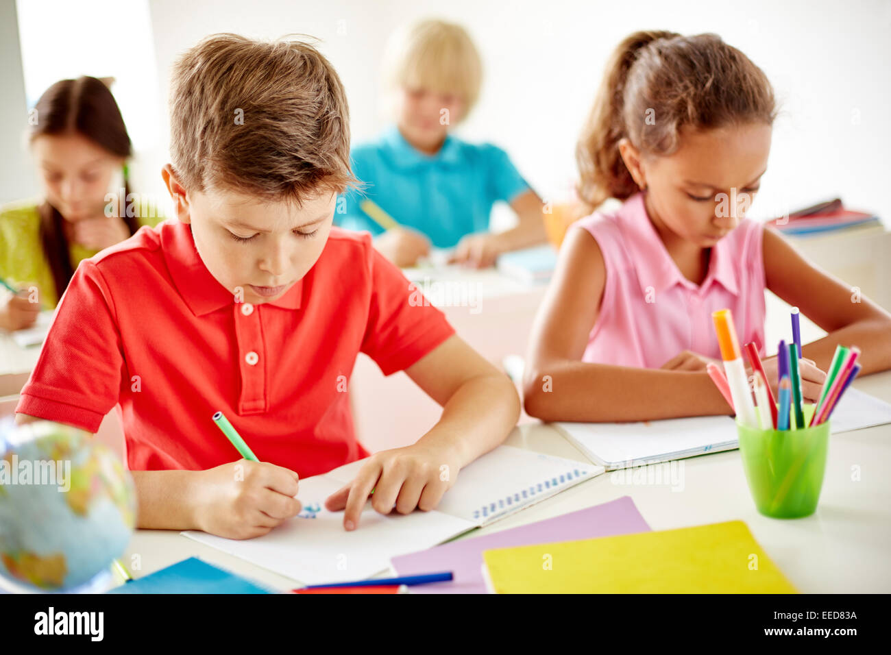 Several classmates drawing with pencils at lesson Stock Photo - Alamy