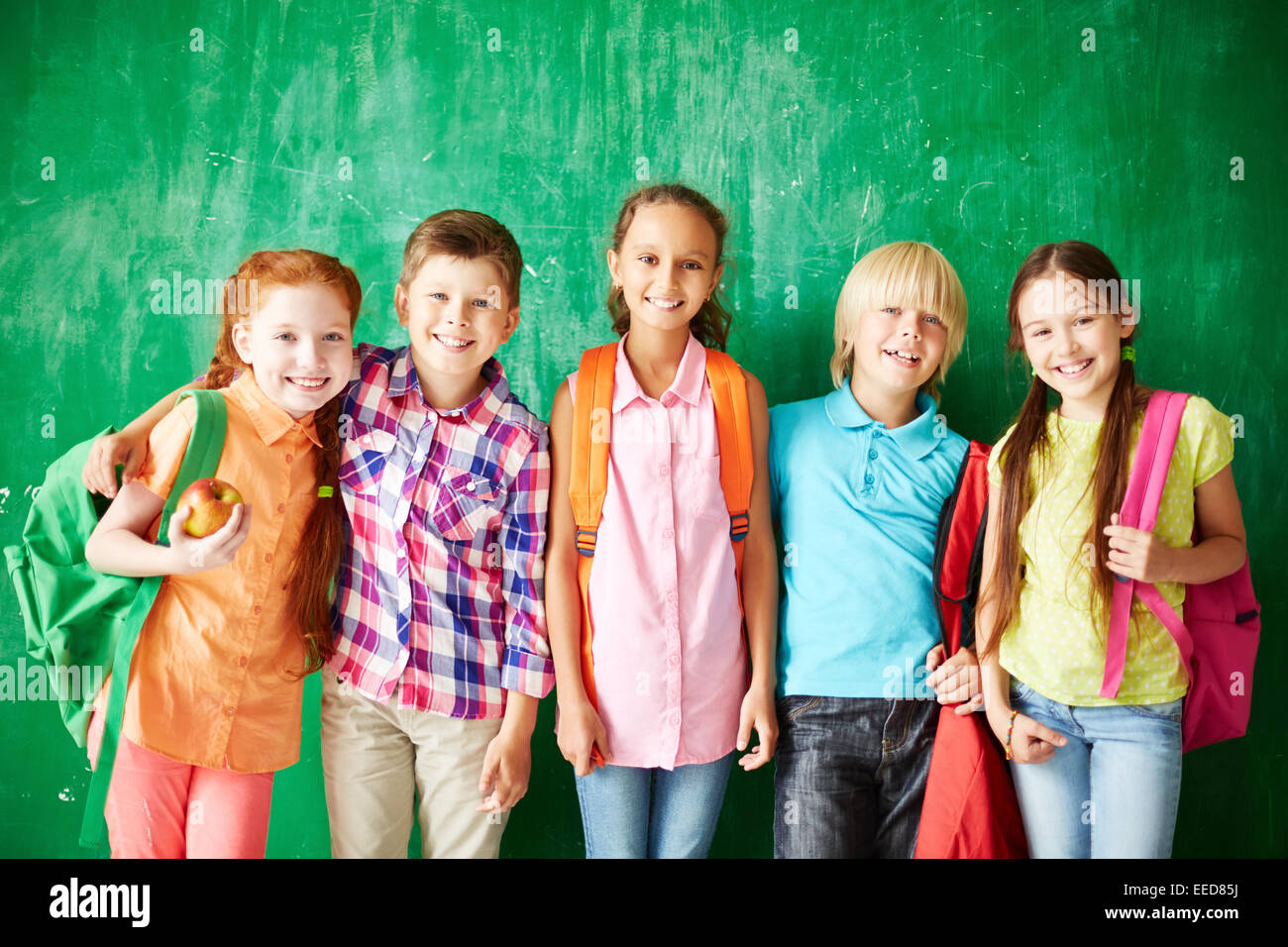 Several classmates with backpacks looking at camera Stock Photo - Alamy