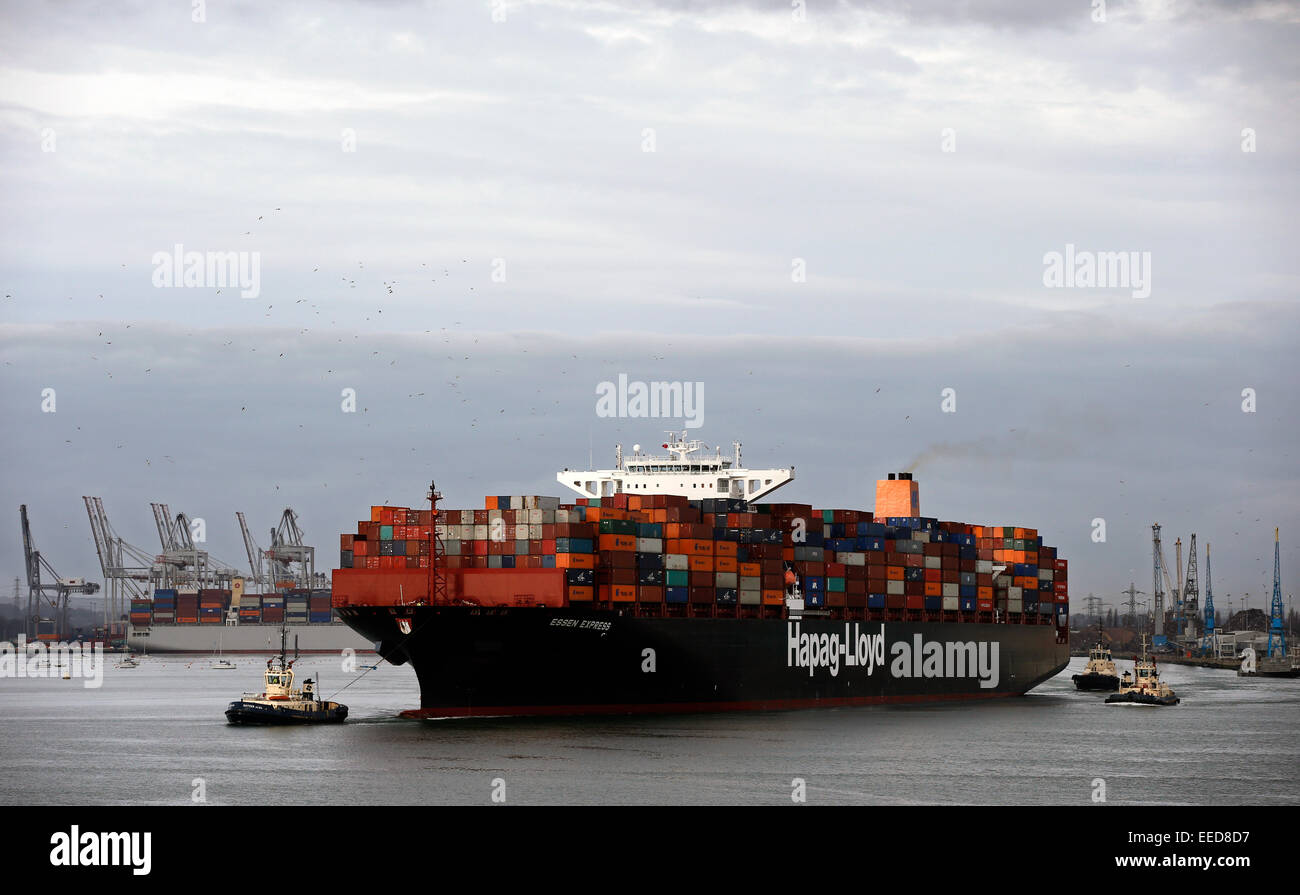 Essen Express container ship is assisted by tug boats in Southampton ...