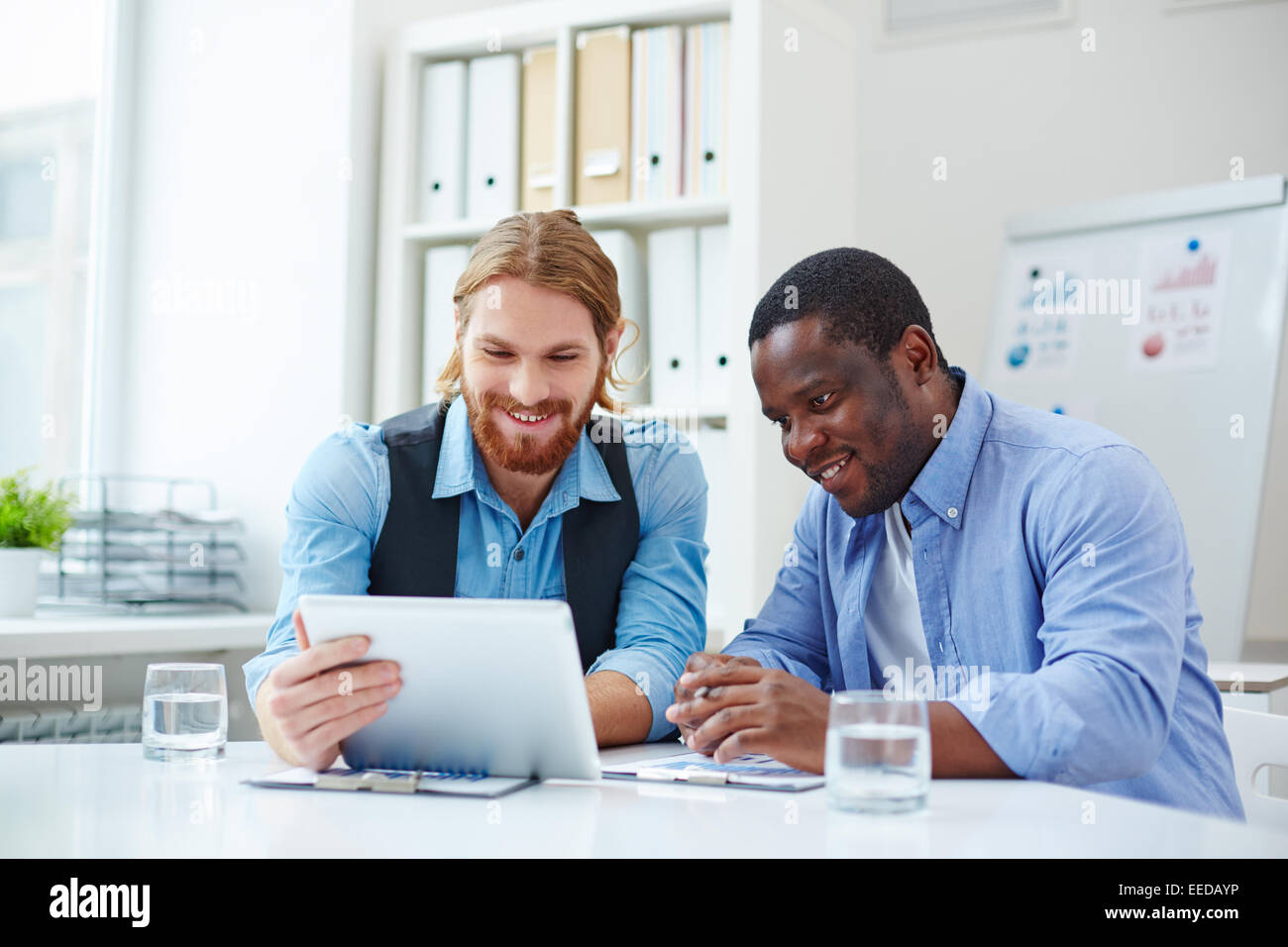 Two smiling businessmen networking in office Stock Photo - Alamy