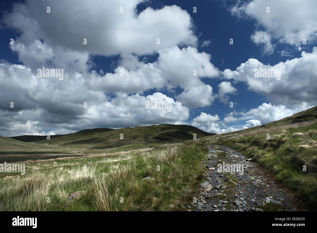 Road across mountainside Stock Photo - Alamy