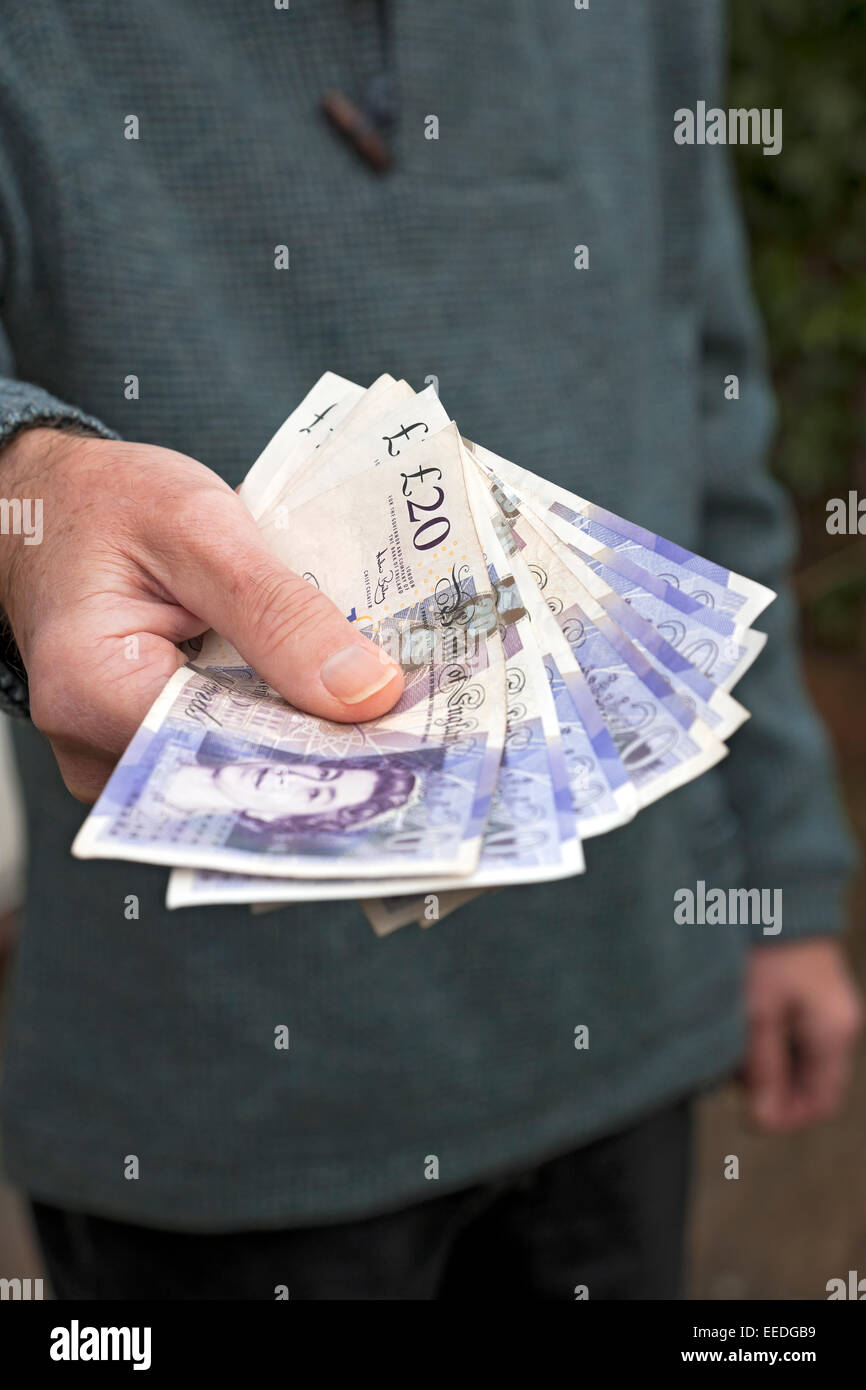 Close up of man person holding English money banknotes banknote cash £ ...