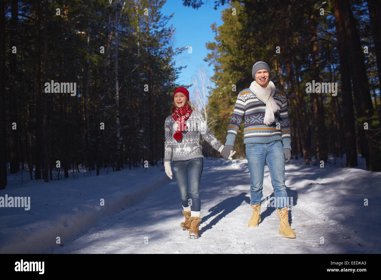 Amorous and ecstatic couple taking walk in winter forest Stock Photo ...