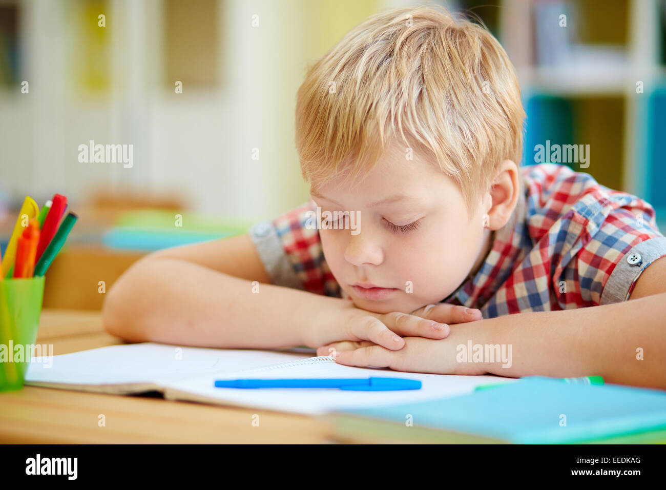 Cute boy napping by desk in classroom Stock Photo - Alamy