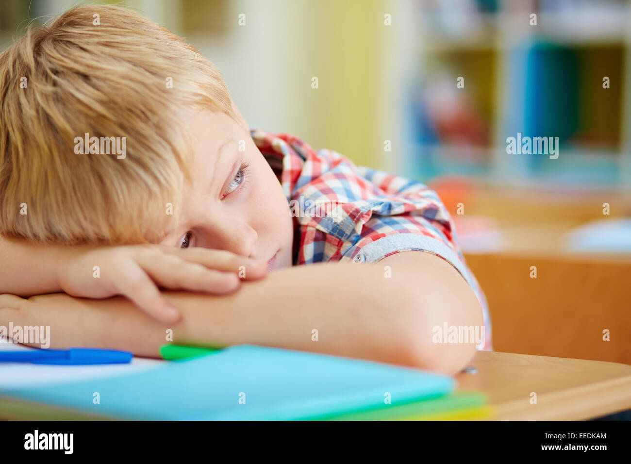 Tired schoolboy having rest Stock Photo - Alamy